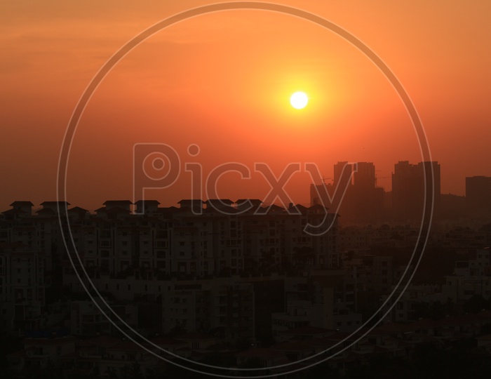 Image of Sunset Over High Rise Buildings Scape With Bright Sun As ...