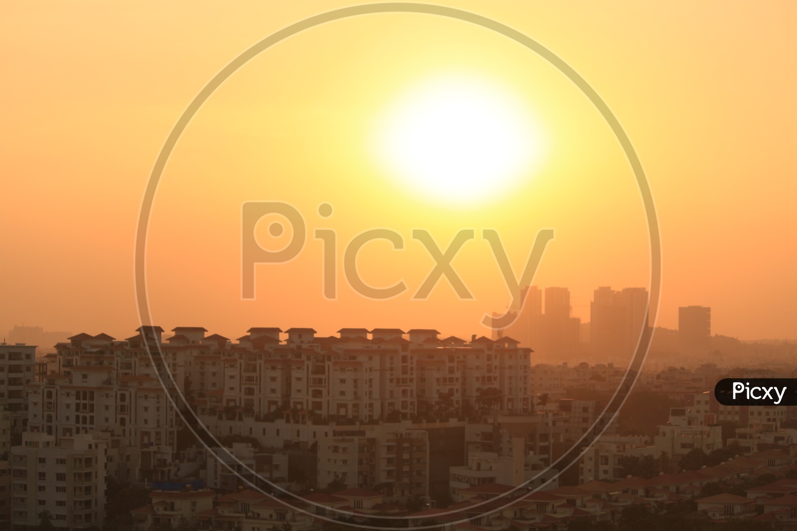 Image of Sunset Over High Rise Buildings Scape With Bright Sun As ...
