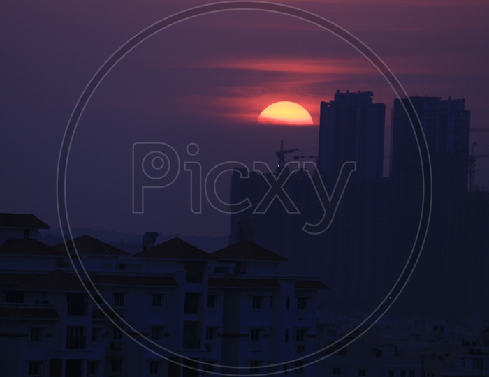 Image of Sunset Over High Rise Buildings Scape With Bright Sun As ...