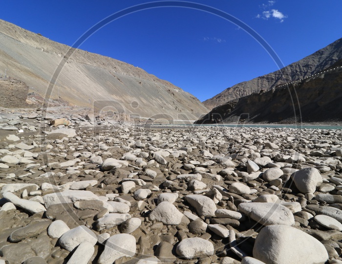 Image of small rocks present beside the river in leh-CW809762-Picxy