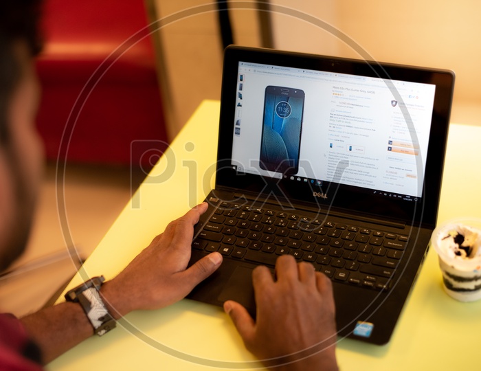 Image of A man using Amazon, e-commerce website for shopping on a ...