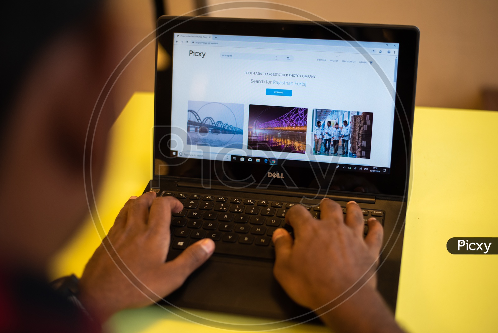 Image of A man browing stock photos in Picxy.com-DW108745-Picxy