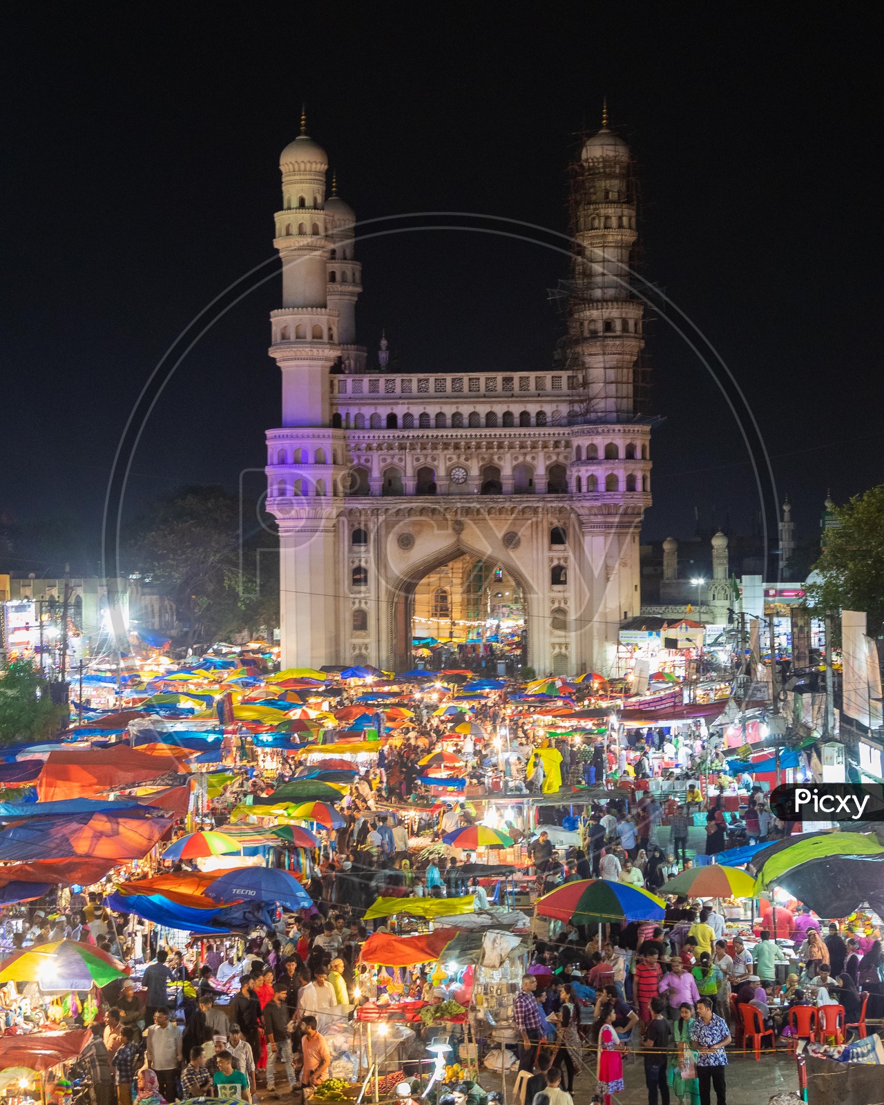 Image of Crowd during the night in street bazaar with charminar in ...