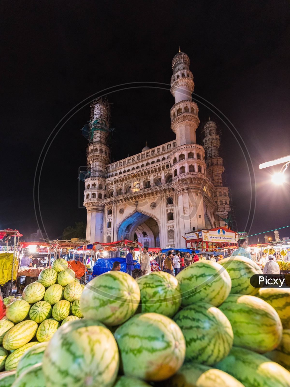 Image of Watermelons by the street during the night with Charminar in ...