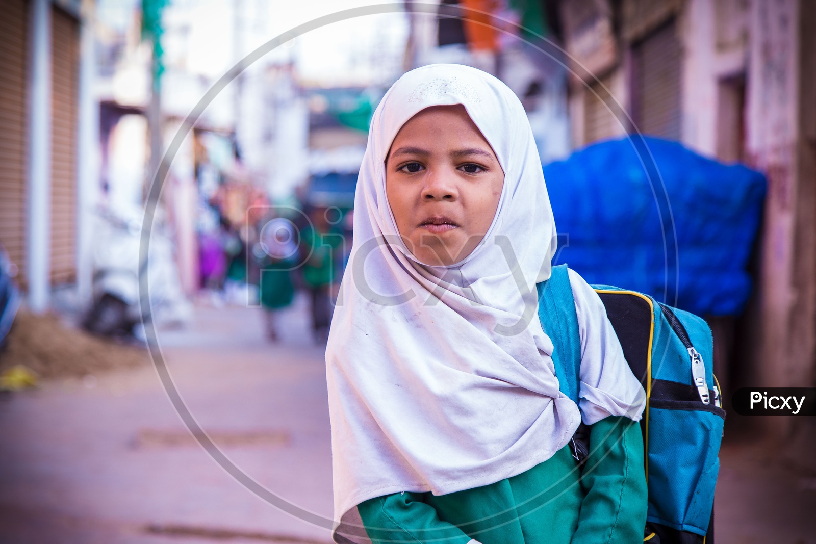 Image of Portrait of a Muslim Girl returning from school with her bag ...
