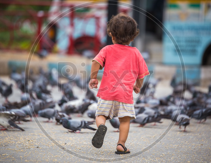 Image of Rag picker boy child in front of the school kids-DQ860155-Picxy