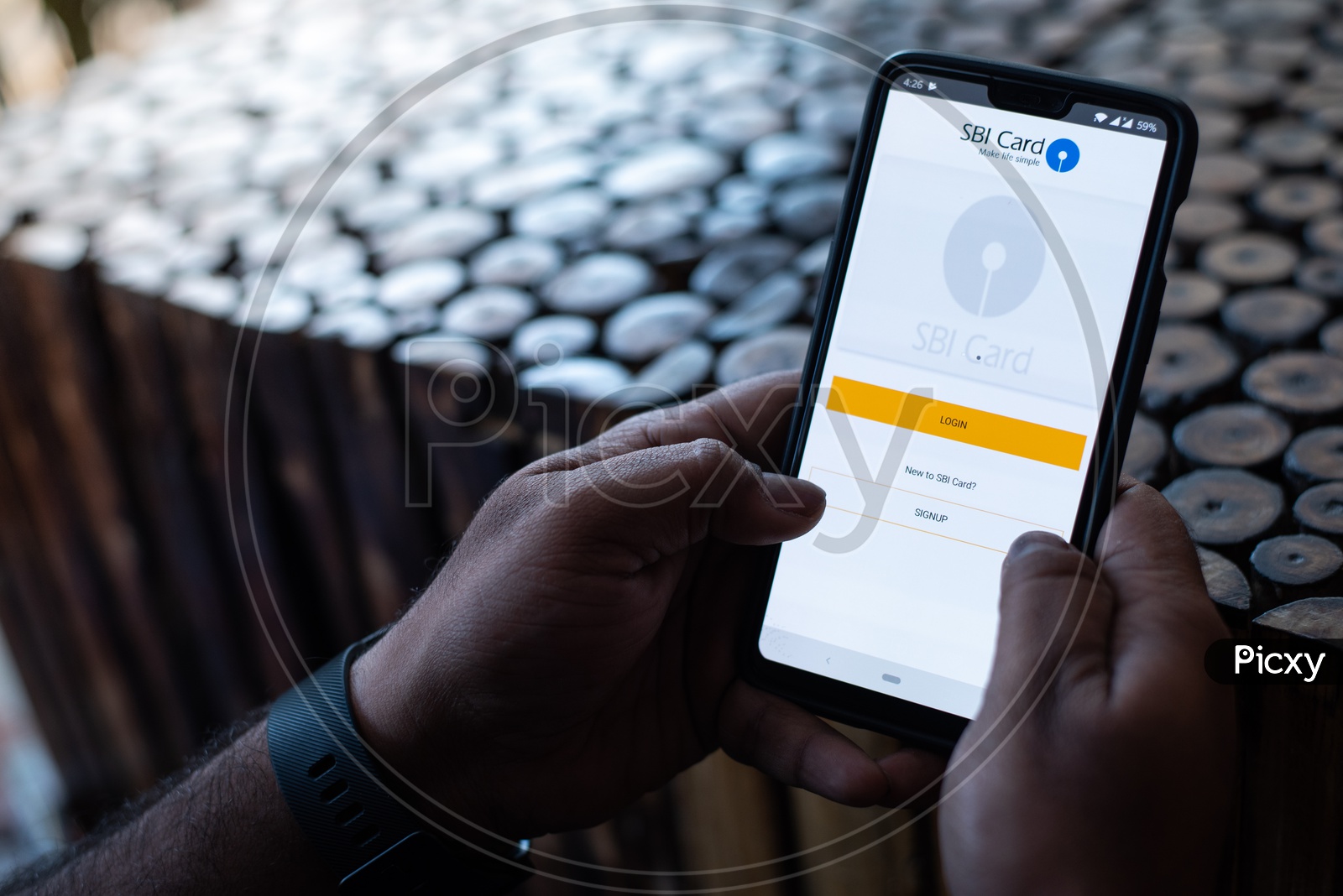 Image of Indian Man using SBI Card app in Smart Phone-KG385153-Picxy