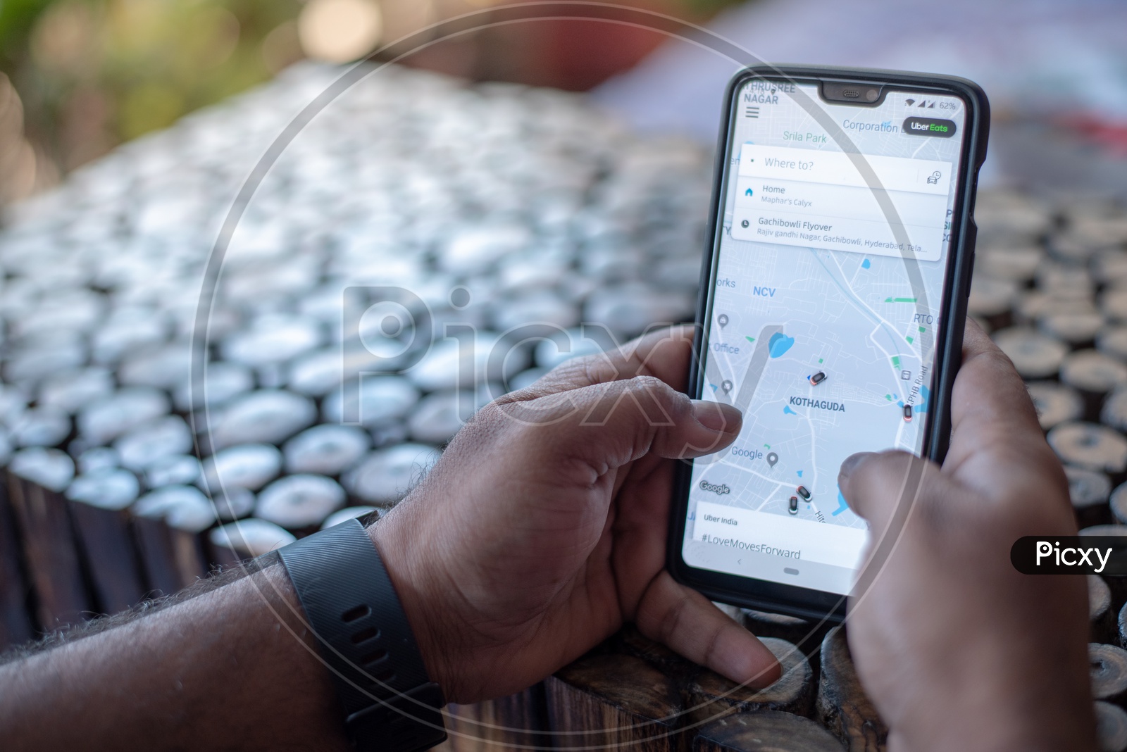 Image of Indian Man using UBER EATS app for ordering food online in ...