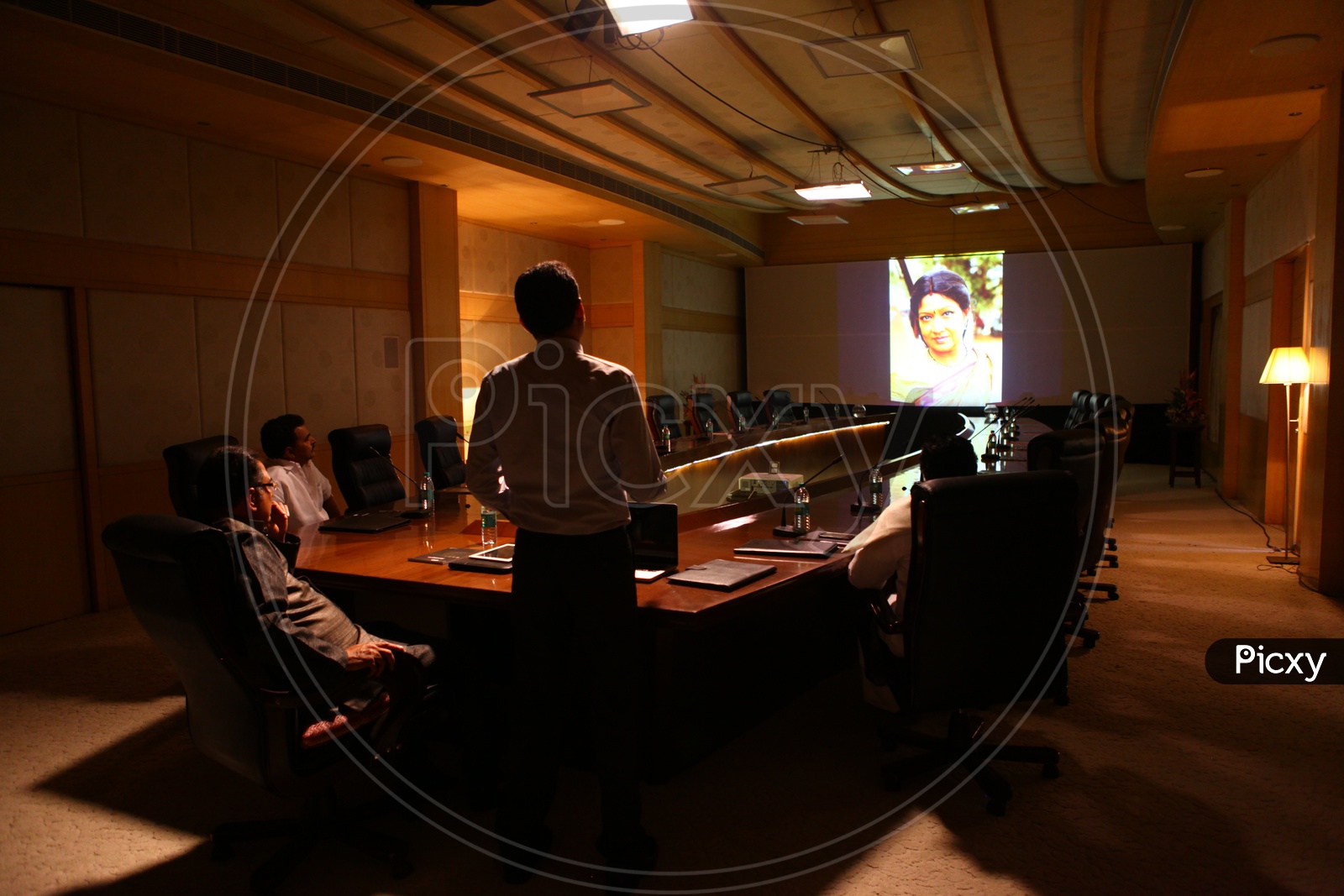 Image of Actors watching the movie run on the display in a conference ...