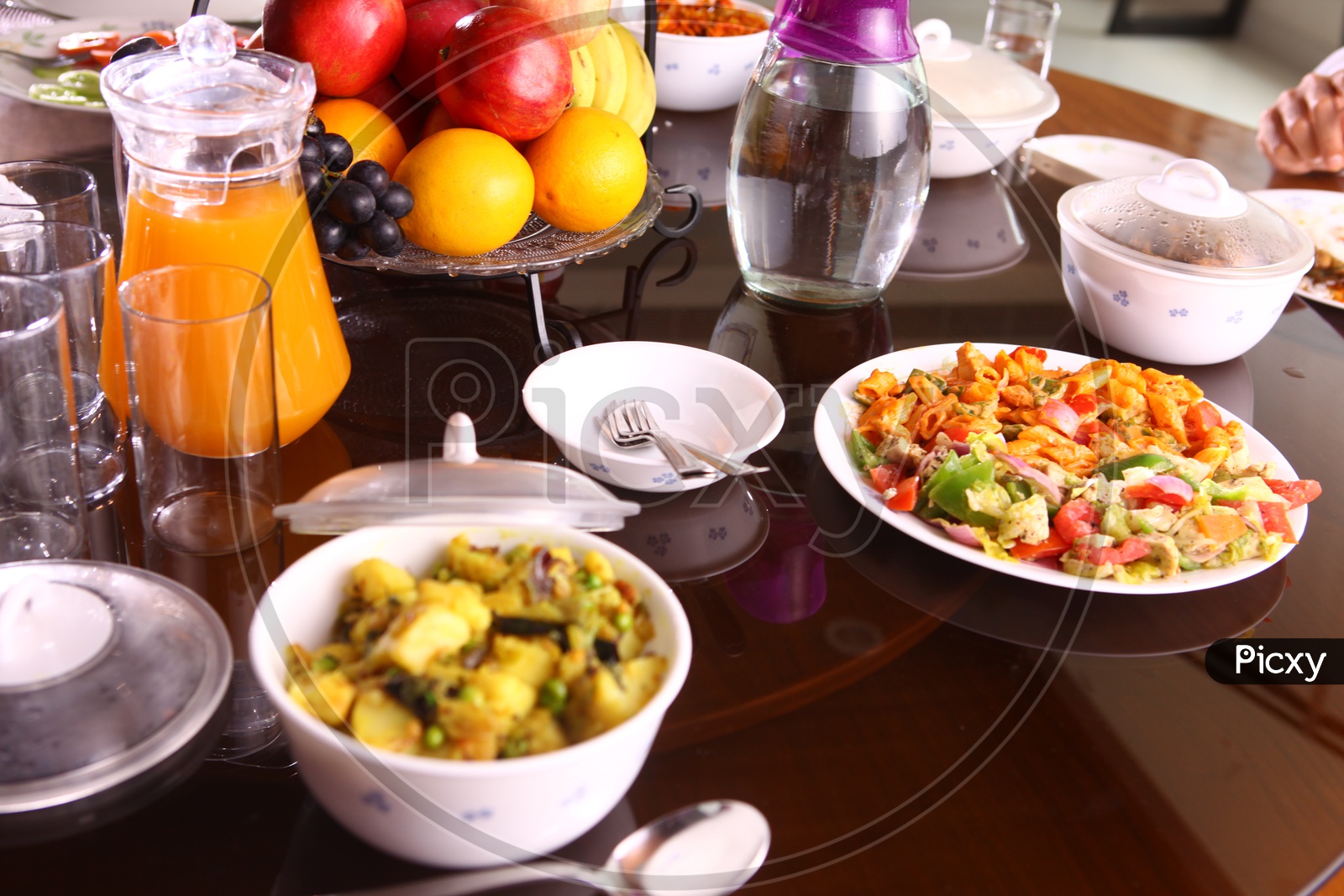 Image of Food served on a dining table in glass and ceramic ware ...