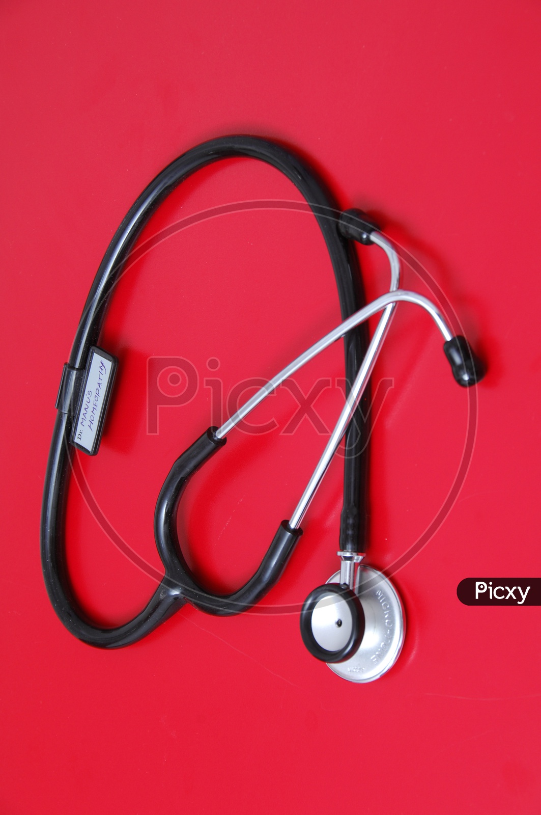 Image of Photograph of stethoscope on red background-VI934285-Picxy