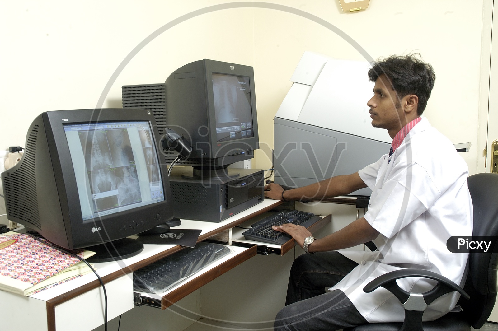 Image of Technician Monitoring The MRI Scan In a Lab-WX790442-Picxy