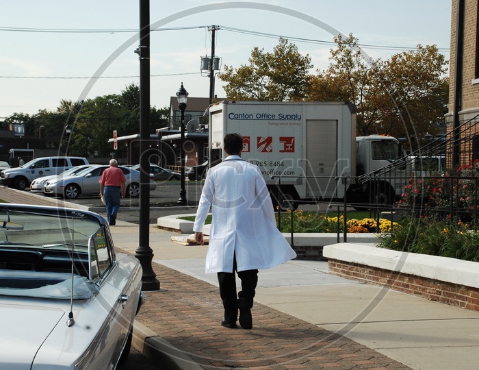 Image of A male doctor walking on the road-EK095177-Picxy