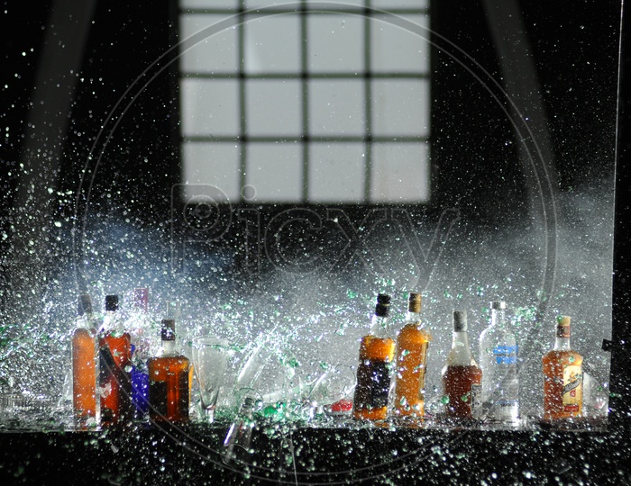Image of Liquor Bottles breaking With Splashing of liquid-NU630267-Picxy
