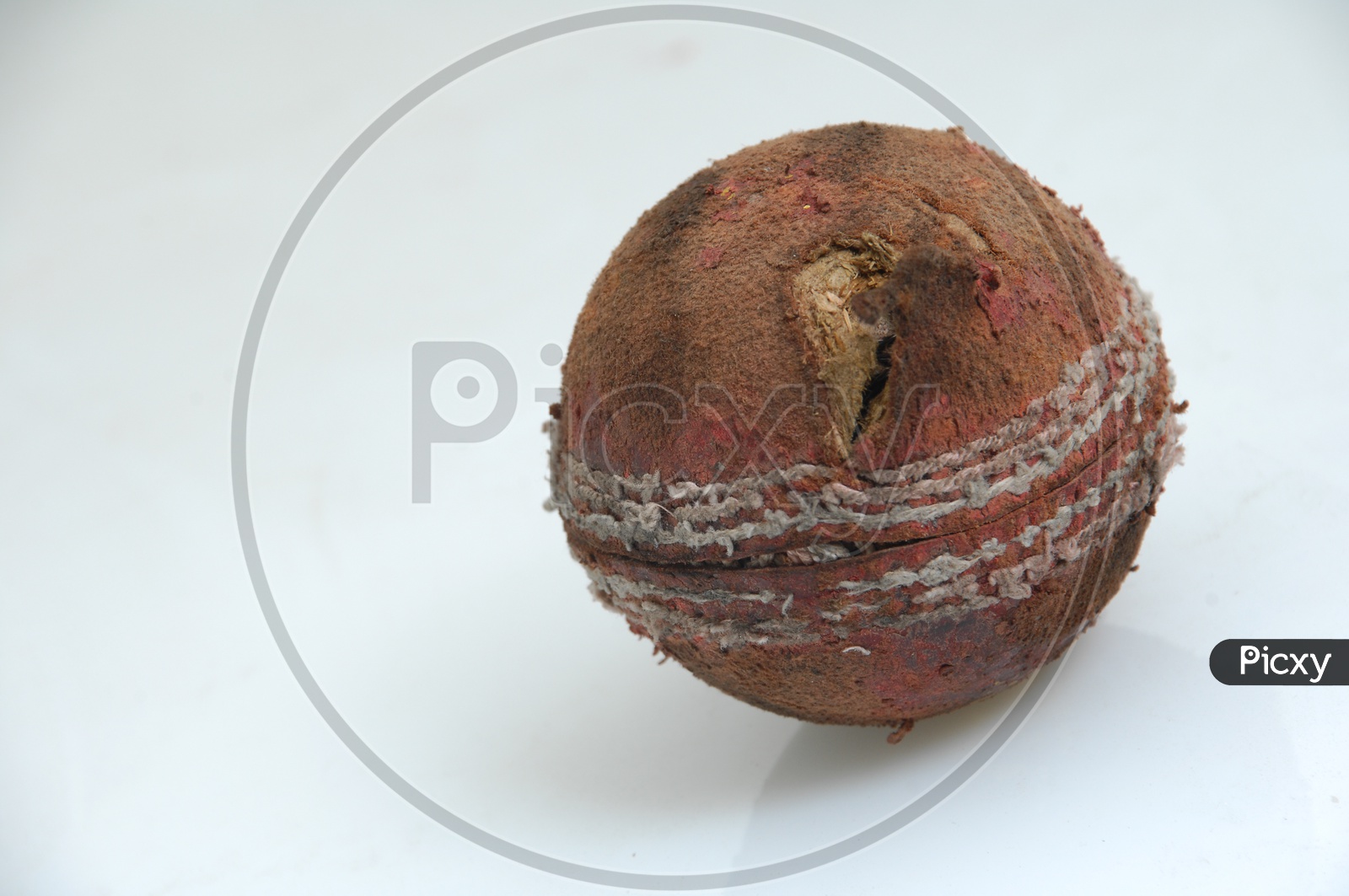Image of A used and worn out cricket ball in white background-UW640644 ...