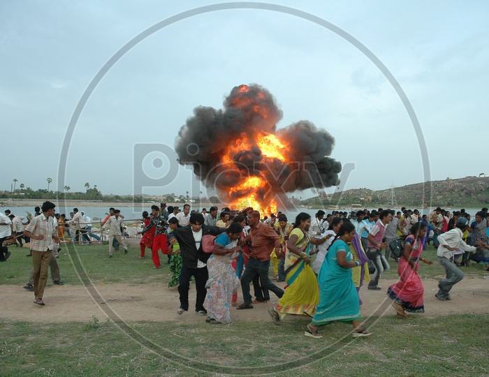 Image of People are running during a Bomb Blast in a an open area ...