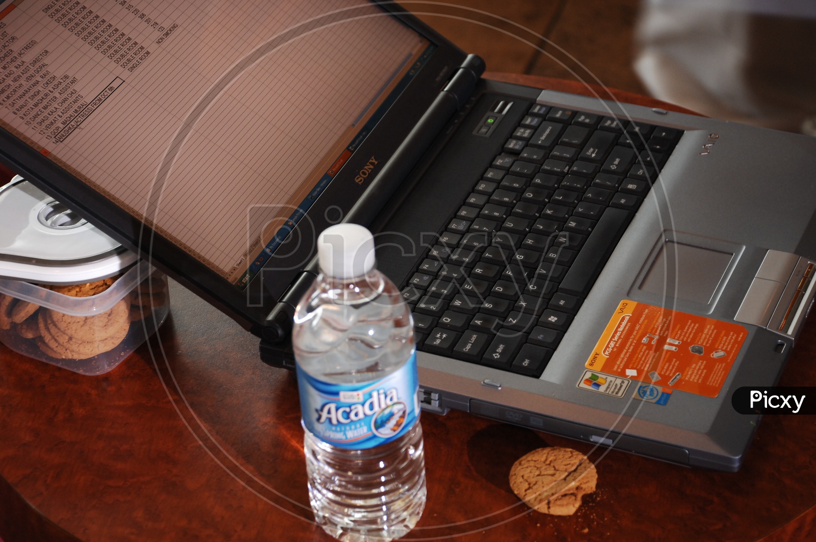 Image of Water bottle beside the laptop-KY869581-Picxy