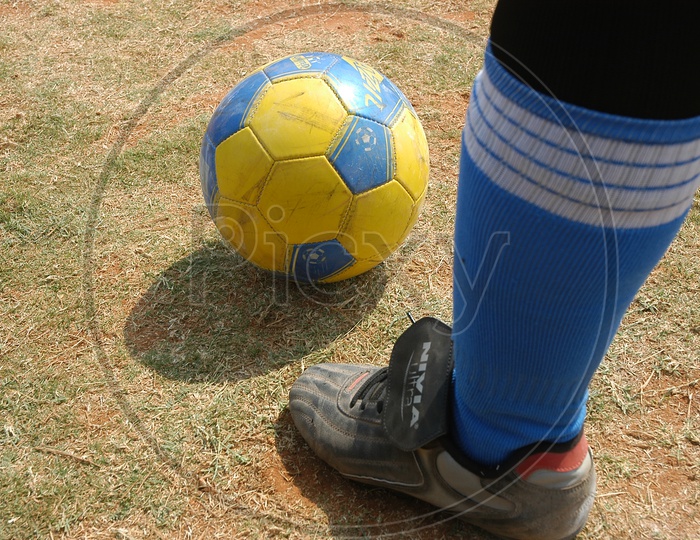 Image of A Football Player Shoe And Ball Closeup-DC226254-Picxy