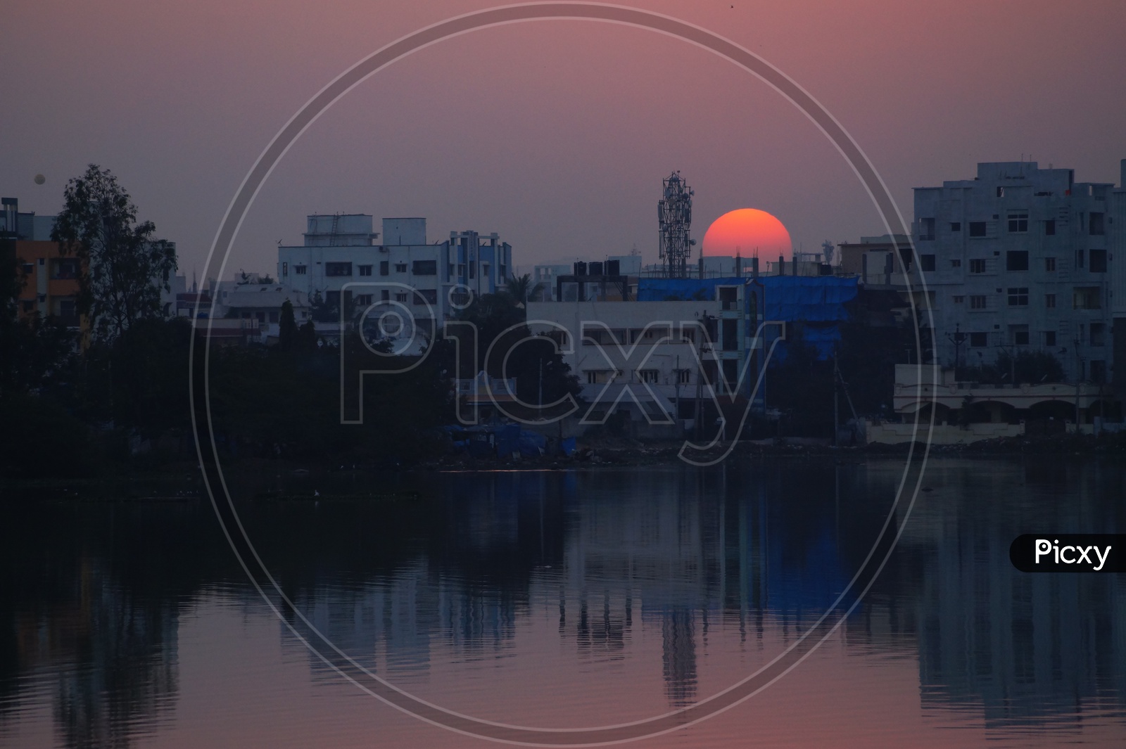 Image of Sunrise over buildings at Saroornagar lake-KA556533-Picxy