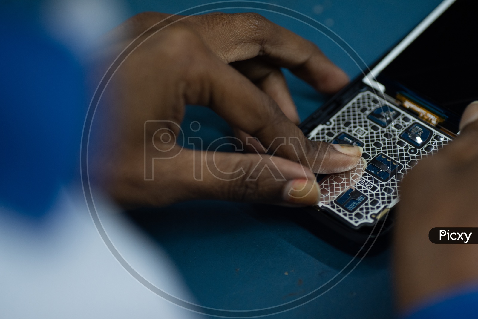 Image of Technicians Manually Assembling The Mobile Parts in a Mobile Manufacturing Unit ...