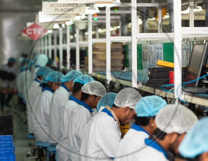 Image of Technicians In a Mobile Manufacturing Unit Manually Assembling ...