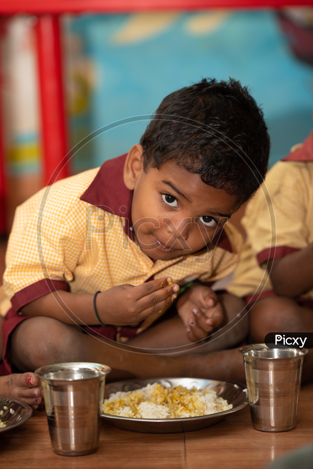 Image of Portrait of a young boy eating his mid day meal in an ...