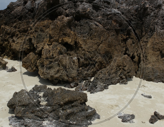 Image of Large black rocks in a beach-SE995310-Picxy
