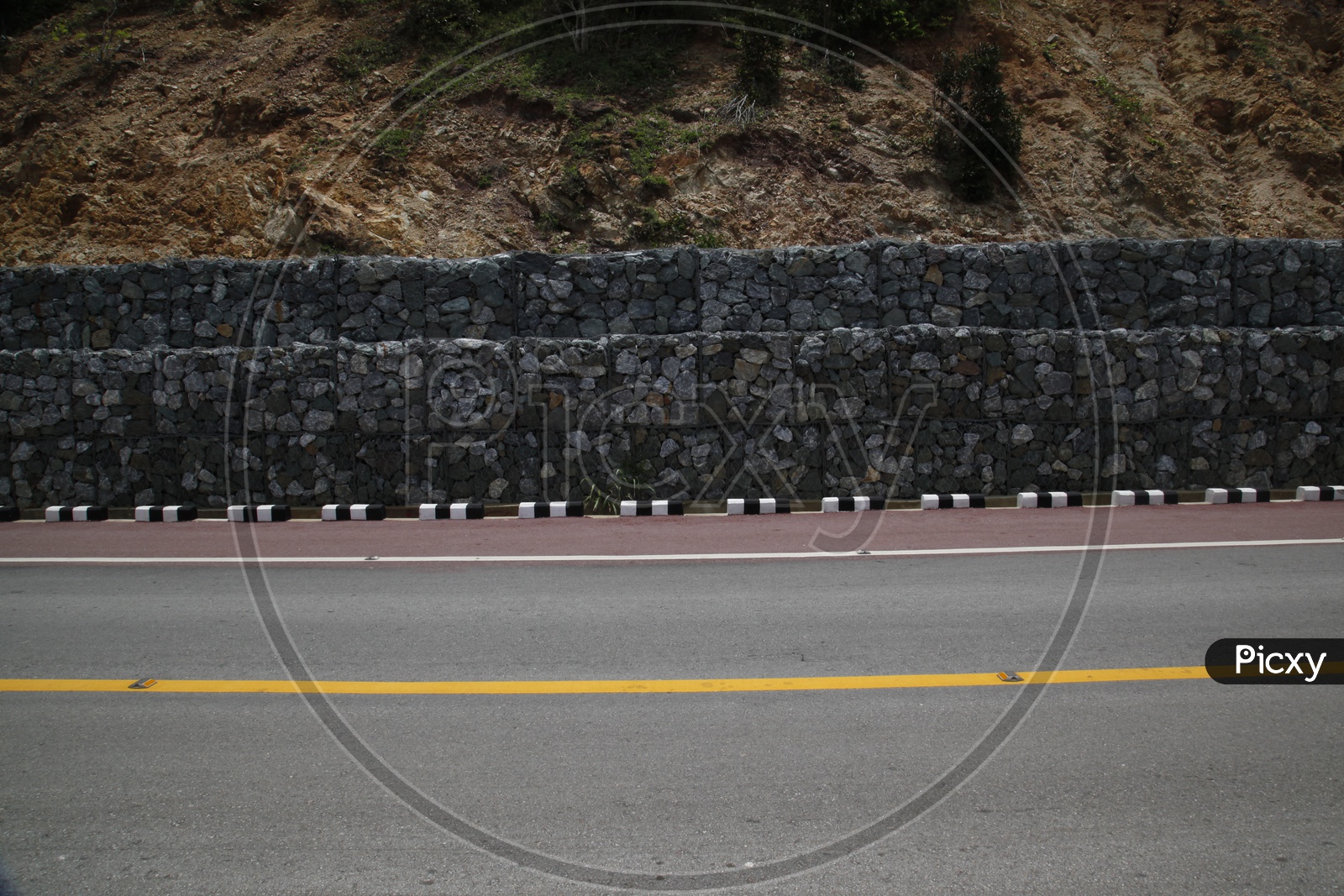 Image of View of rock wall alongside the road-DL553555-Picxy