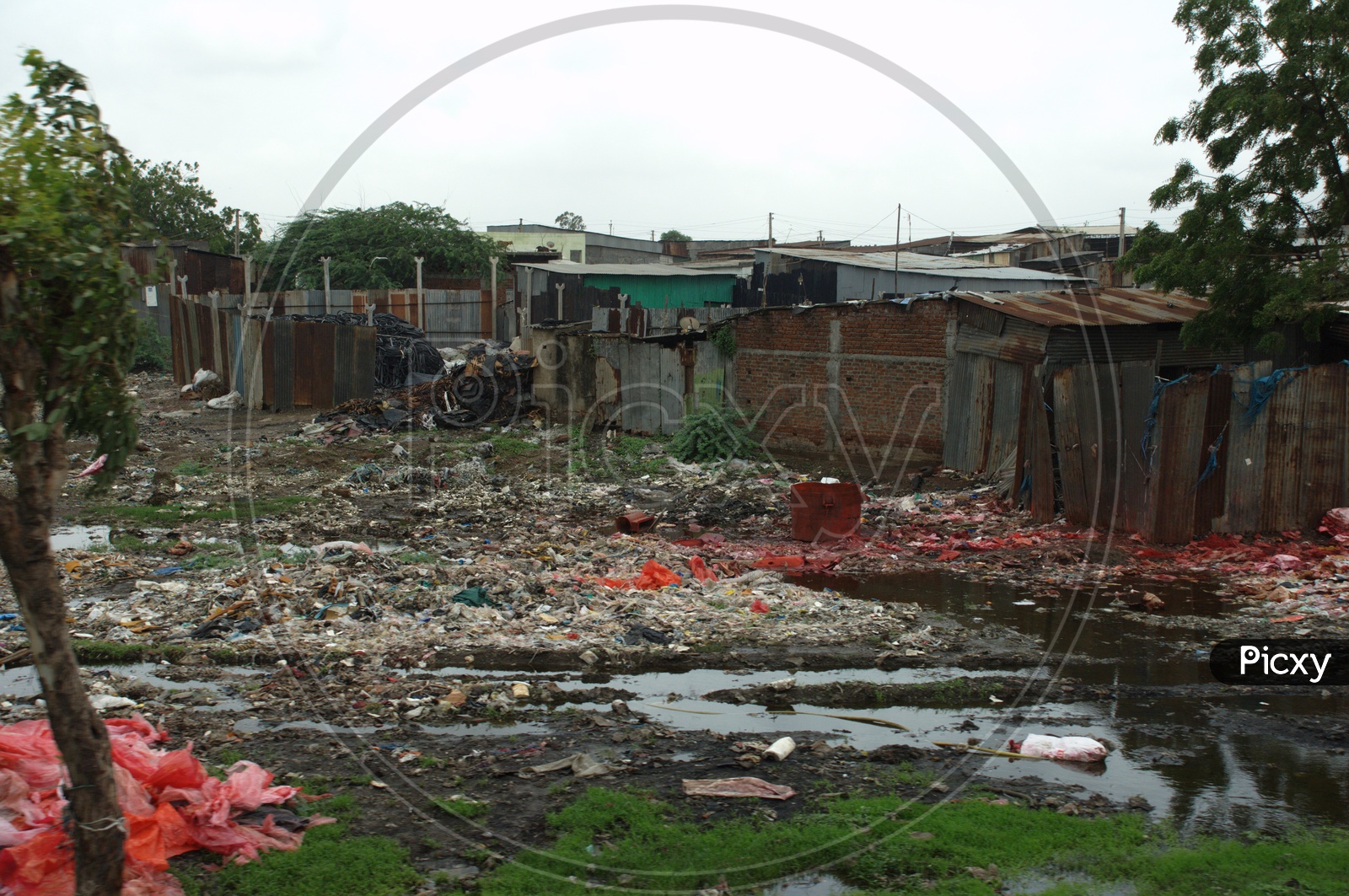 Image of Garbage Dumped At Slum Area With Steel Sheet Huts Present ...