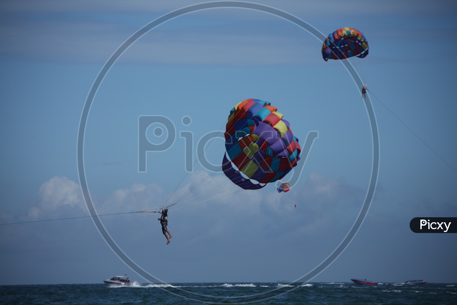 Image of Parasailing towed by motor boats-PJ139877-Picxy