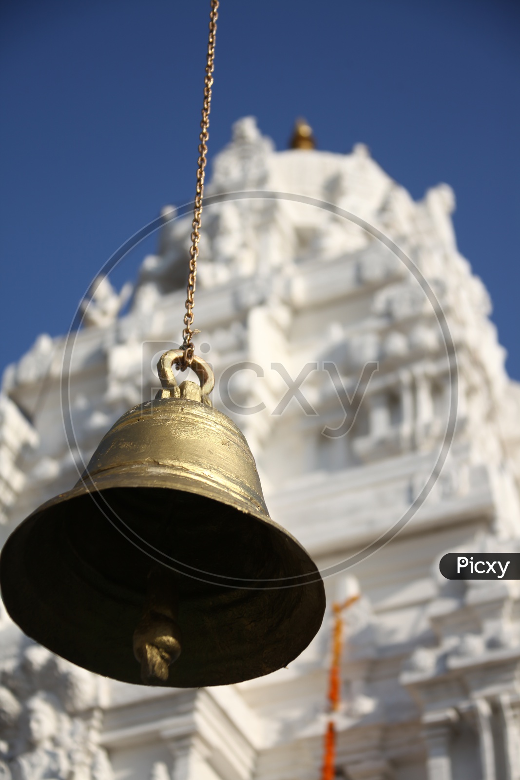 Image of Temple Bells with Gopuram in background-MO394510-Picxy
