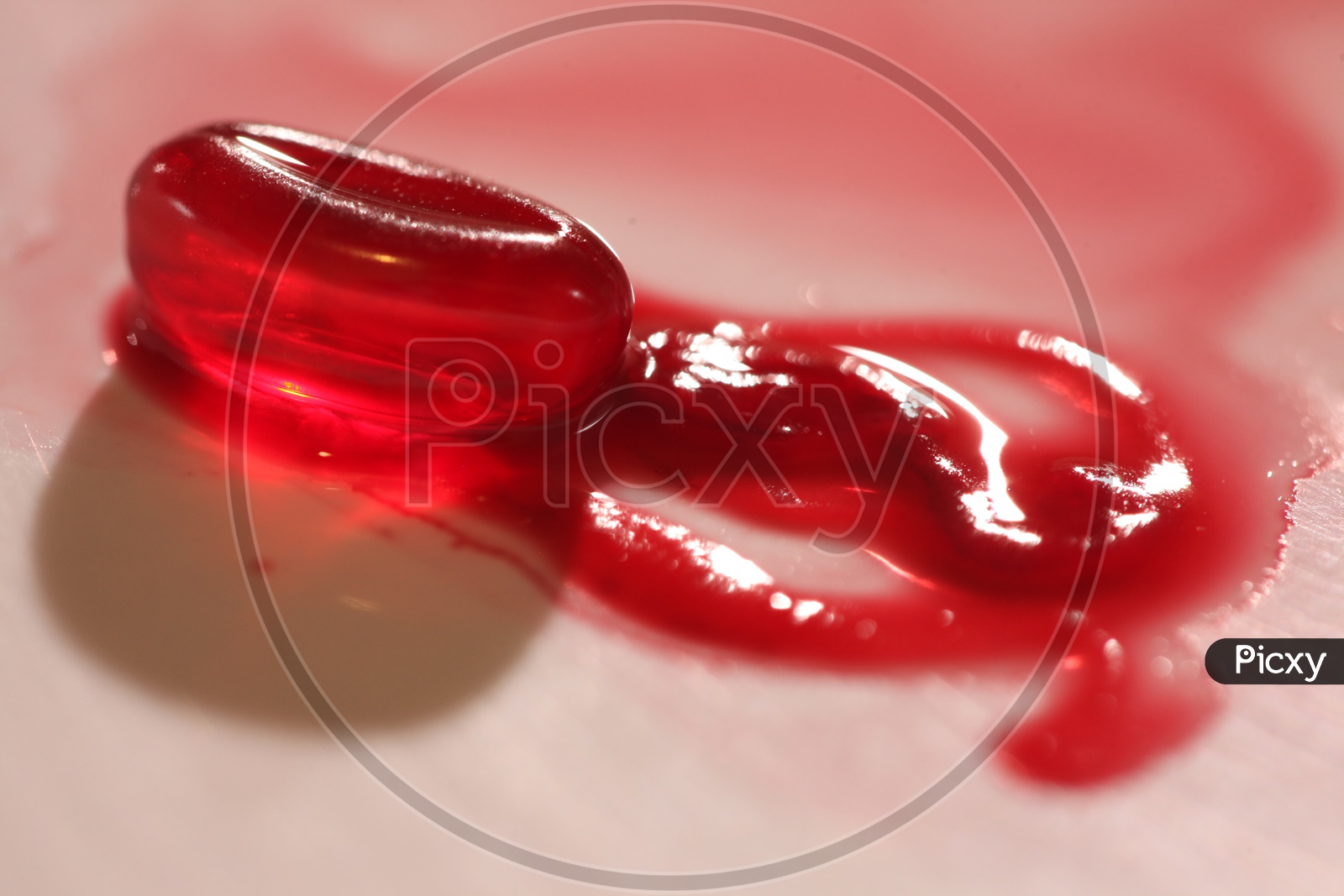Image of Red capsules and liquid-RK199666-Picxy