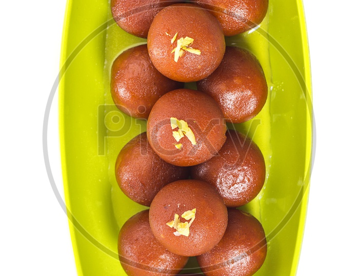Image of Indian Dessert or Sweet Dish Gulab Jamun topped with Pistachio ...