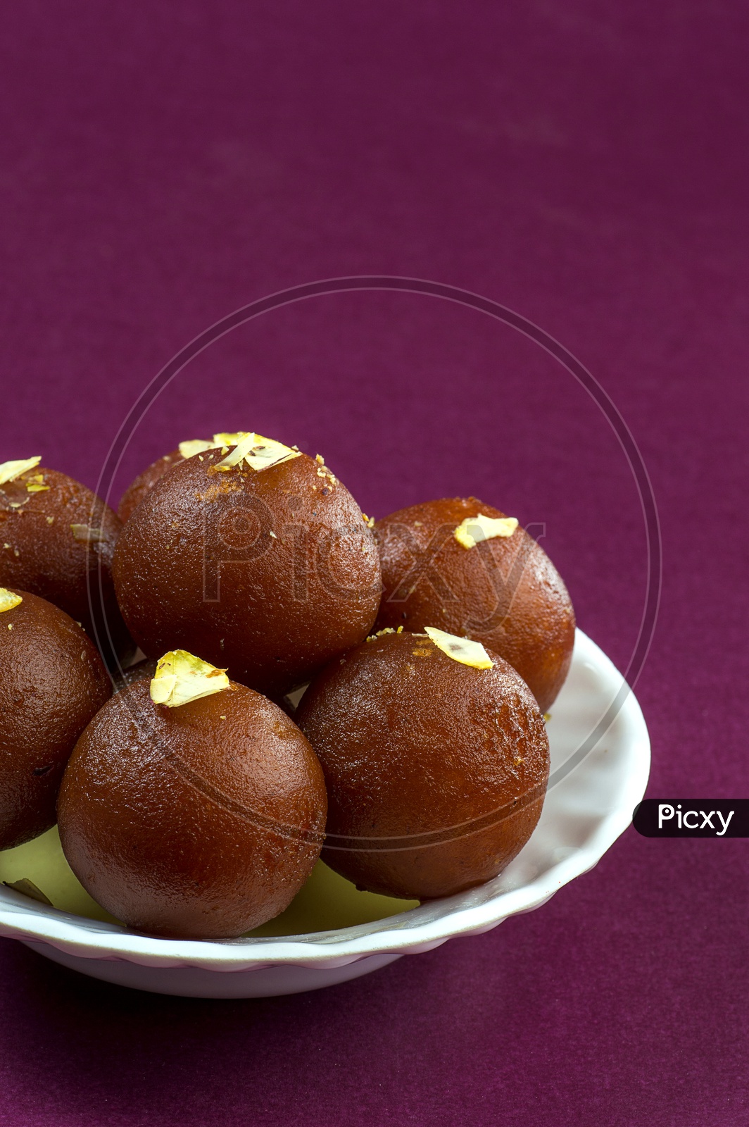 Image of Indian Dessert or Sweet Dish Gulab Jamun topped with Pistachio ...