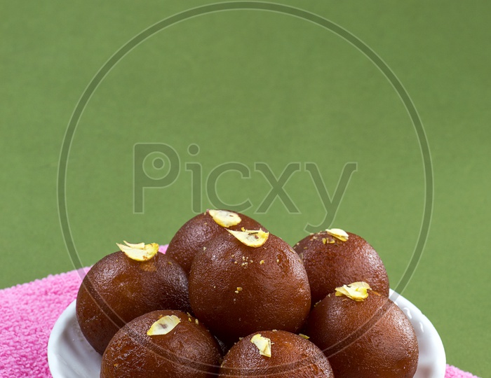 Image of Indian Dessert or Sweet Dish Gulab Jamun topped with Pistachio ...