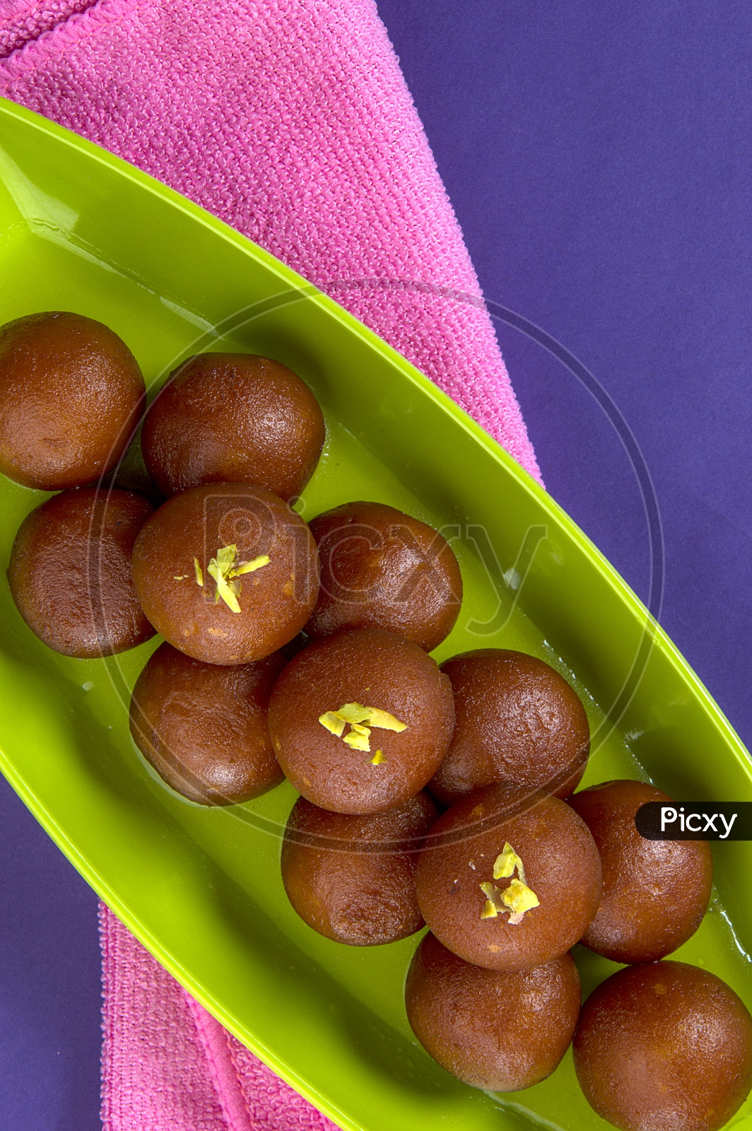 Image of Indian Dessert or Sweet Dish Gulab Jamun topped with Pistachio ...