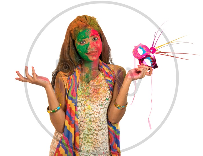 Image of Young girl Filled in Holi Colours holding Carnival Mask and ...