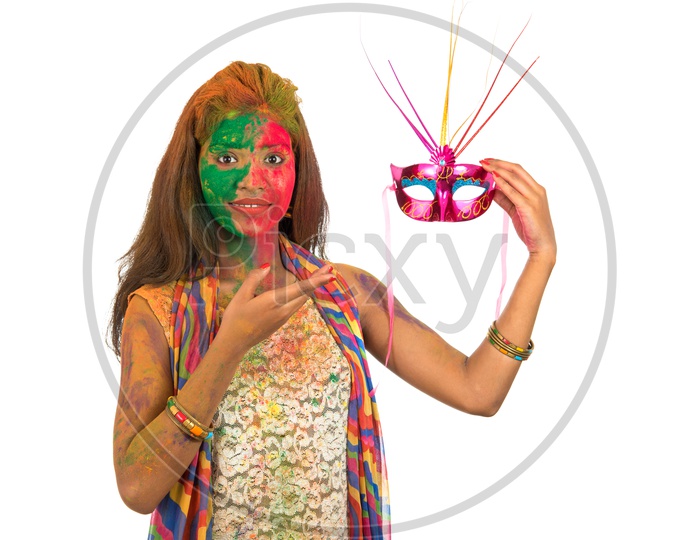 Image of Young girl Filled in Holi Colours holding Carnival Mask and ...