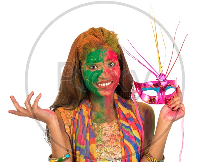 Image of Young girl Filled in Holi Colours holding Carnival Mask and ...