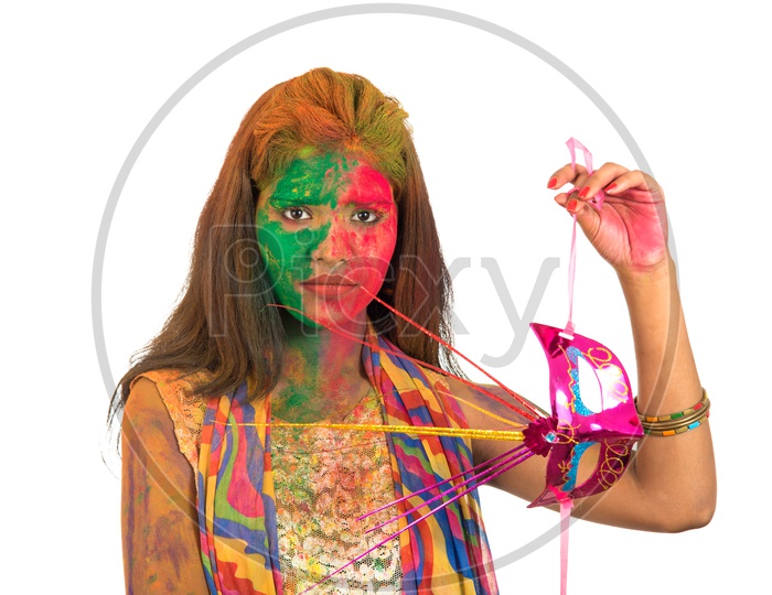 Image of Young girl Filled in Holi Colours holding Carnival Mask and ...