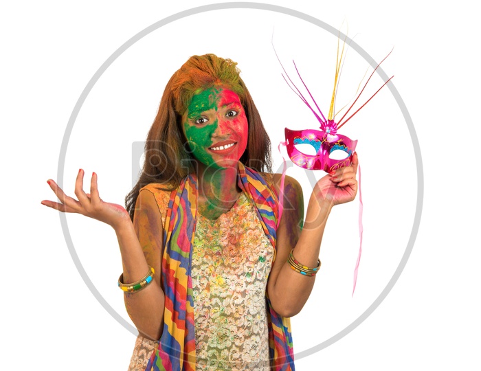 Image of Young girl Filled in Holi Colours holding Carnival Mask and ...