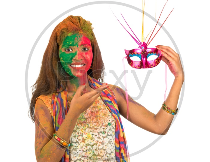 Image of Young girl Filled in Holi Colours holding Carnival Mask and ...