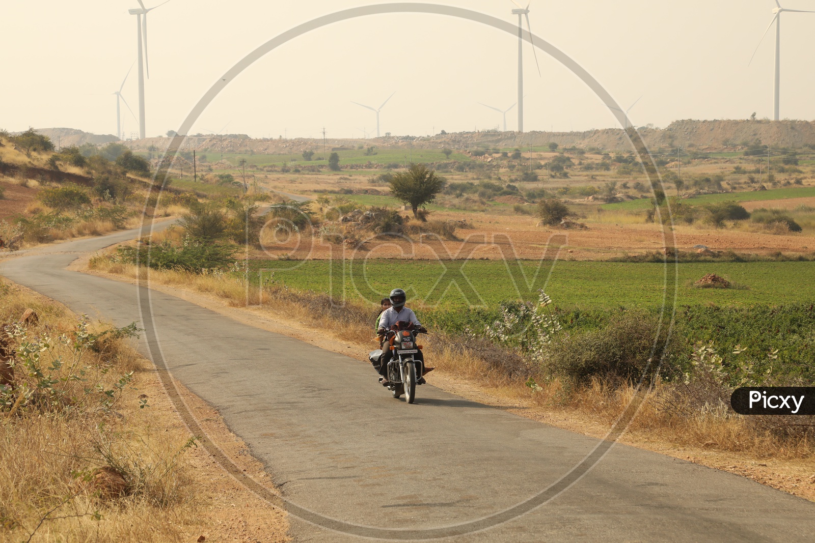 Image of Bike moving on a Single lane road-YD132732-Picxy