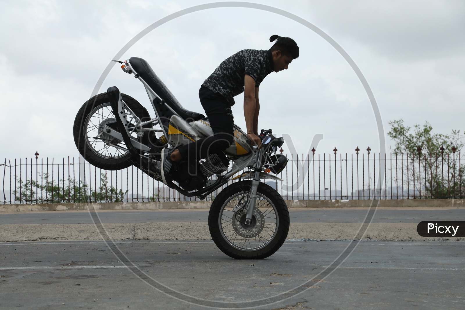 Image of Biker Performing Stunts on Bike-XB401665-Picxy