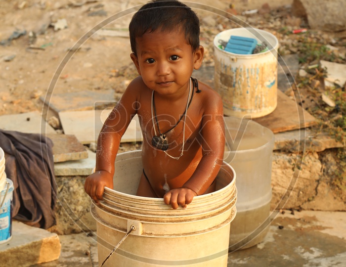 Image of A smiling boy in a bucket-YQ731958-Picxy