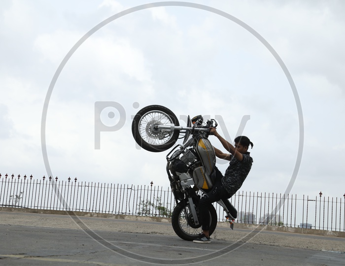 Image of A Biker Performing Stunts On Bike-ZQ528388-Picxy