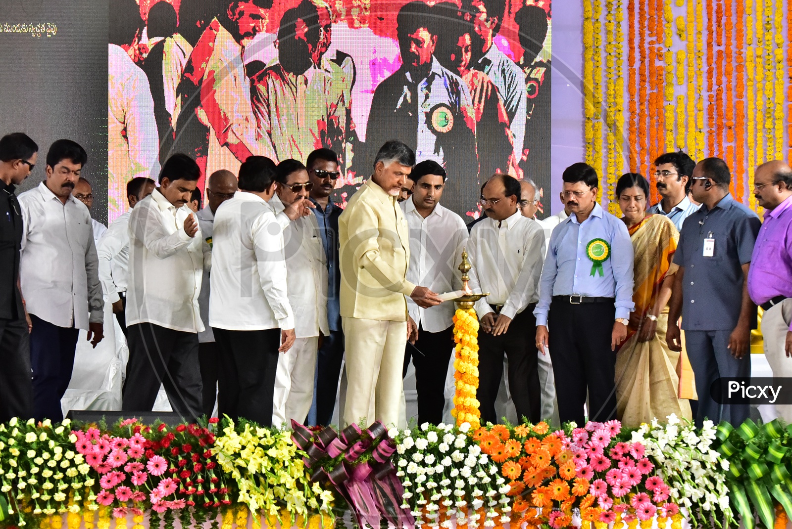 Image of AP Chief Minister Chandra Babu Naidu lighting an oil lamp-TG527781-Picxy