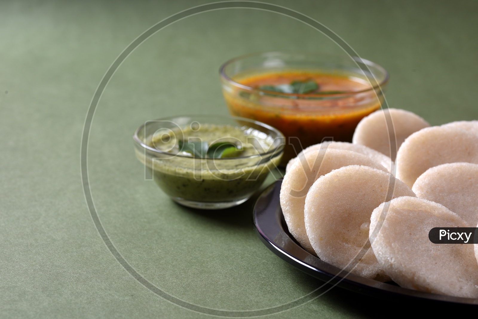 Image of Idli with Sambar and coconut chutney on green background ...