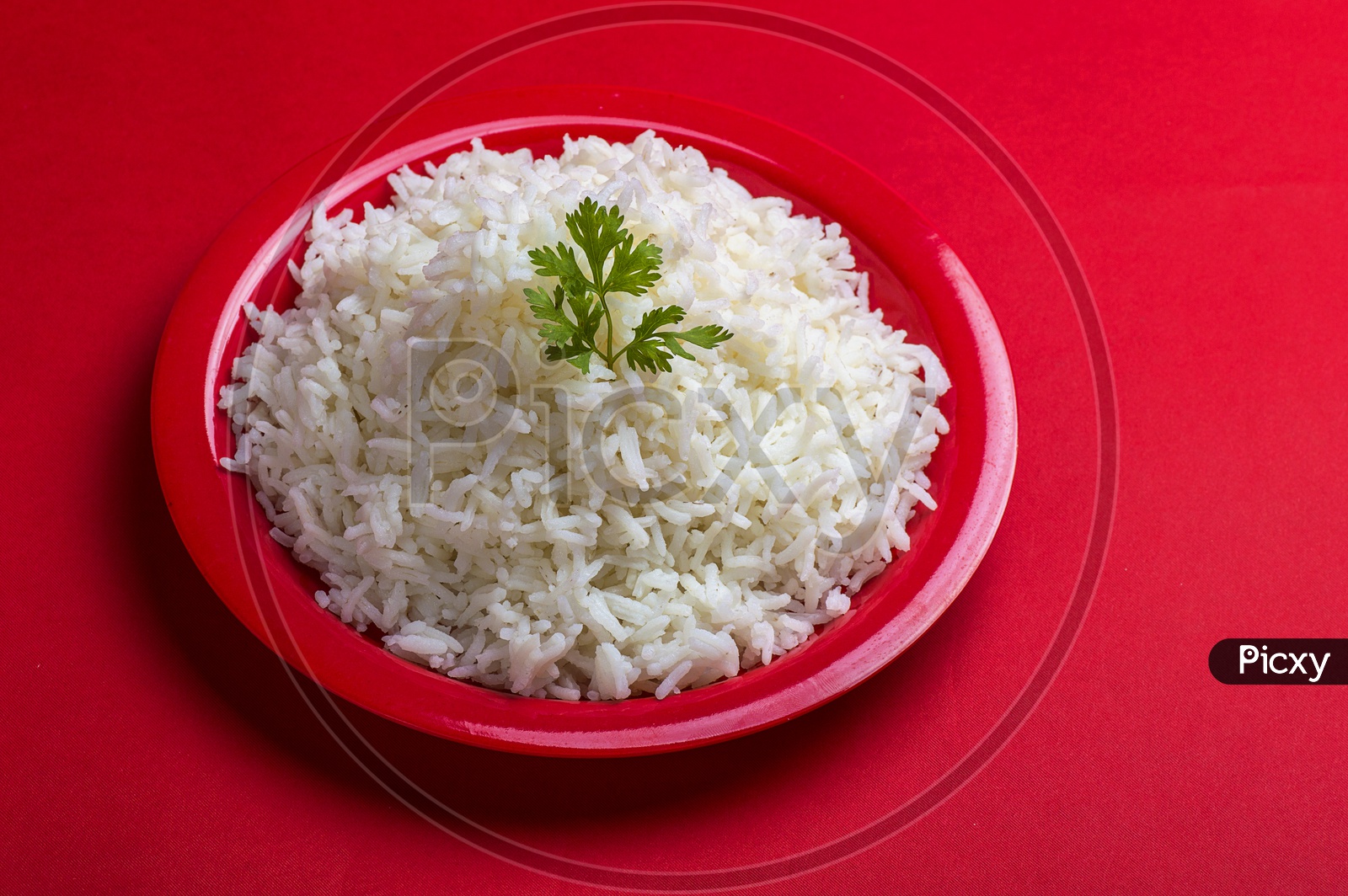 Image of Cooked plain white basmati rice in a red plate on red ...