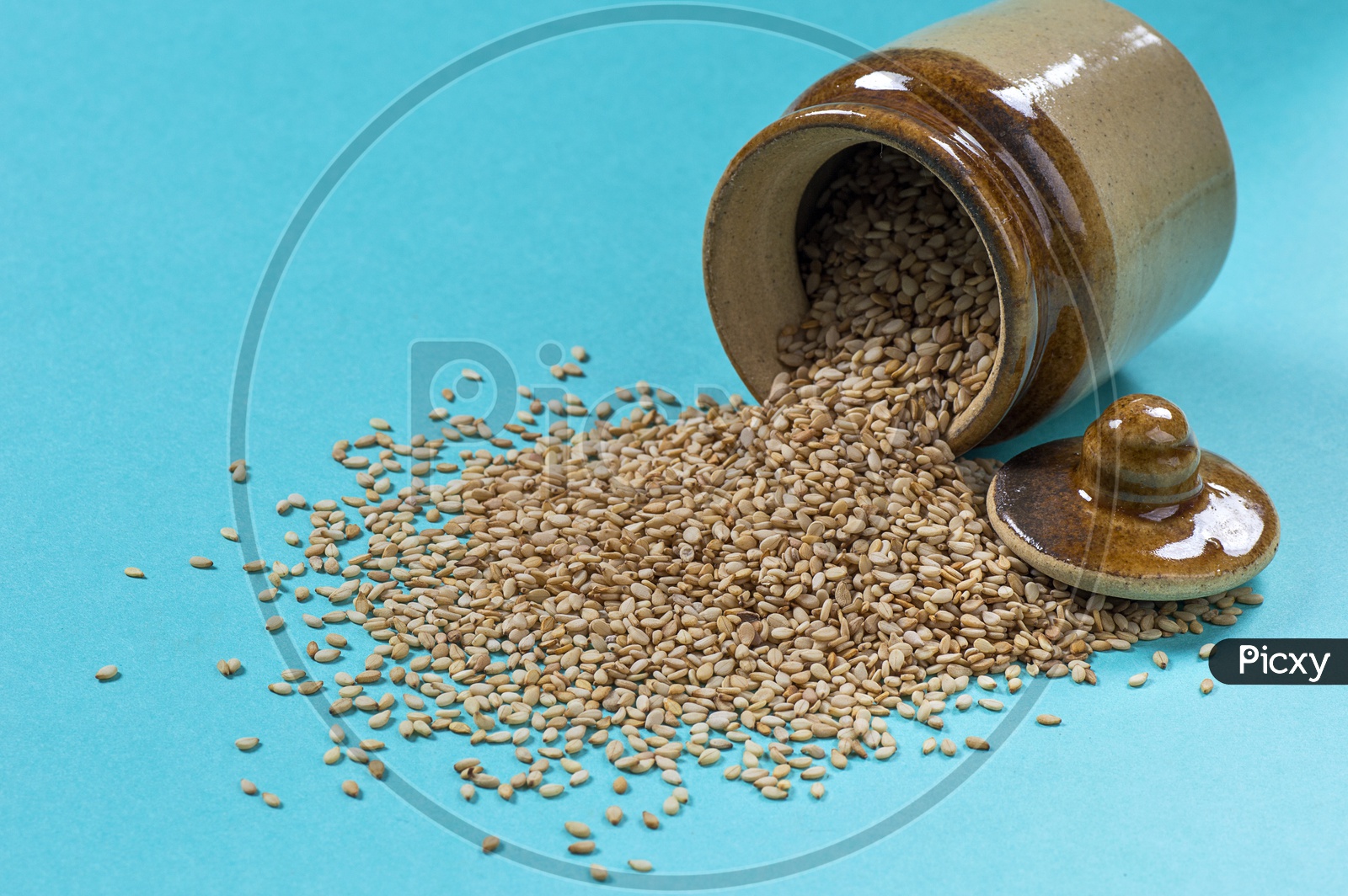 Image of Sesame Seeds in clay pot on blue background-UL418263-Picxy